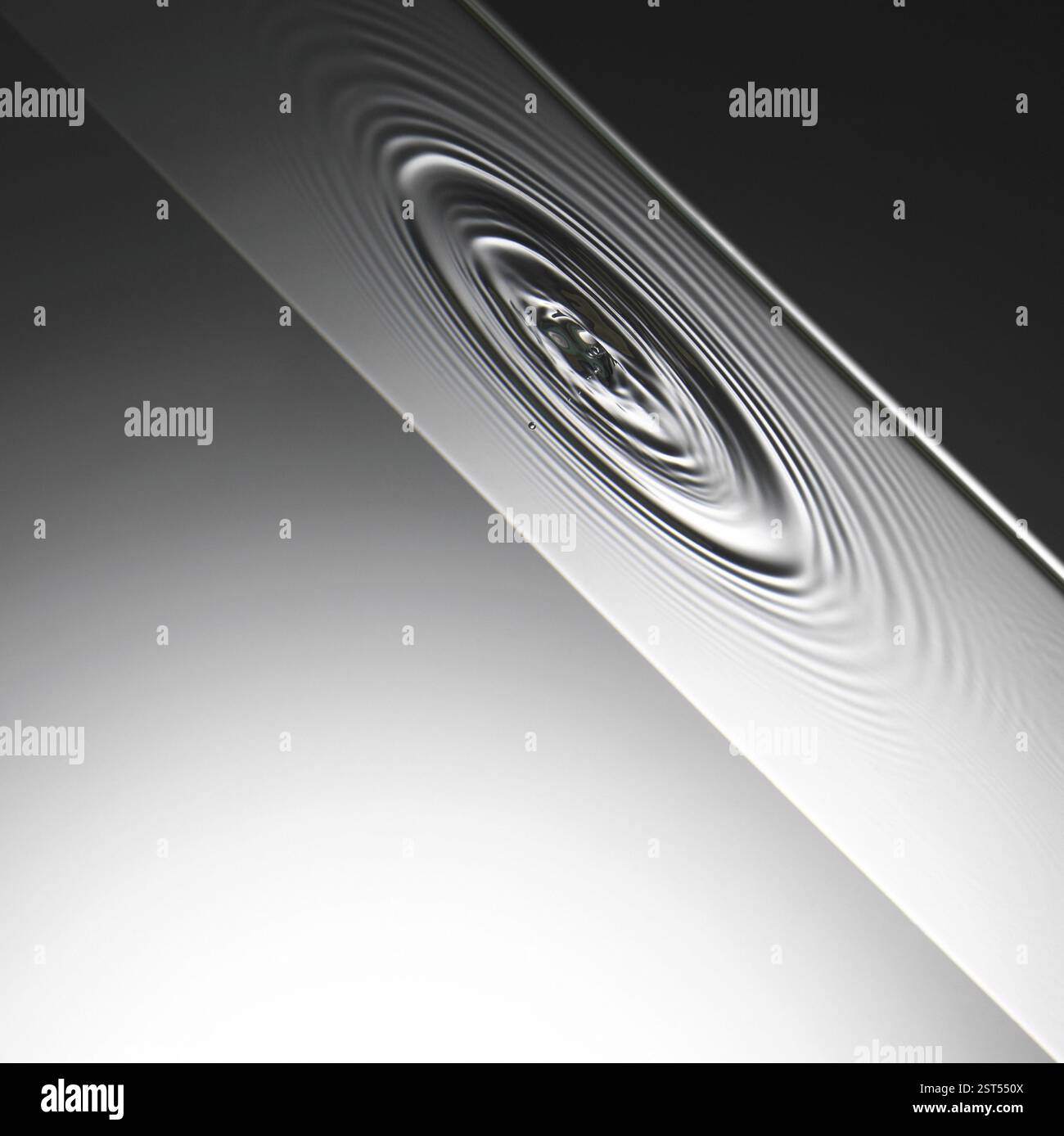 Water drop splash with Ripple grey background Stock Photo - Alamy
