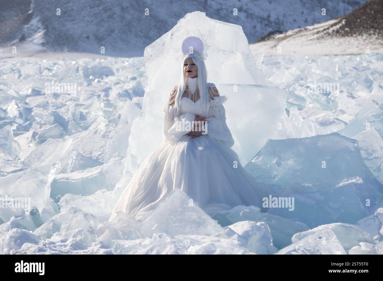Snow Queen in a white gown surrounded by ice shards on Lake Baikal ...
