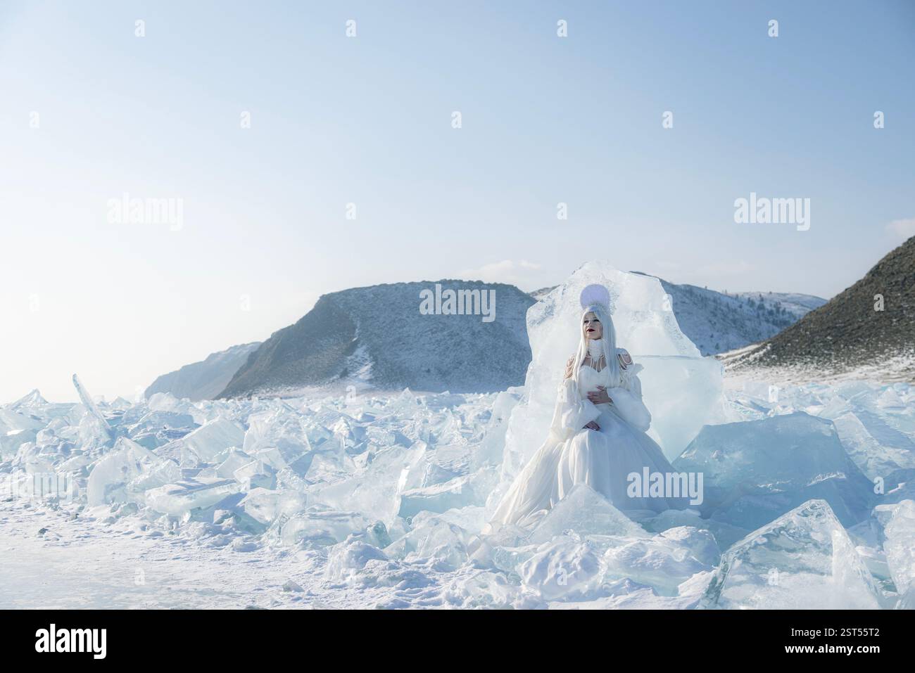 Snow Queen in a white gown among ice shards on Lake Baikal. Magical ...