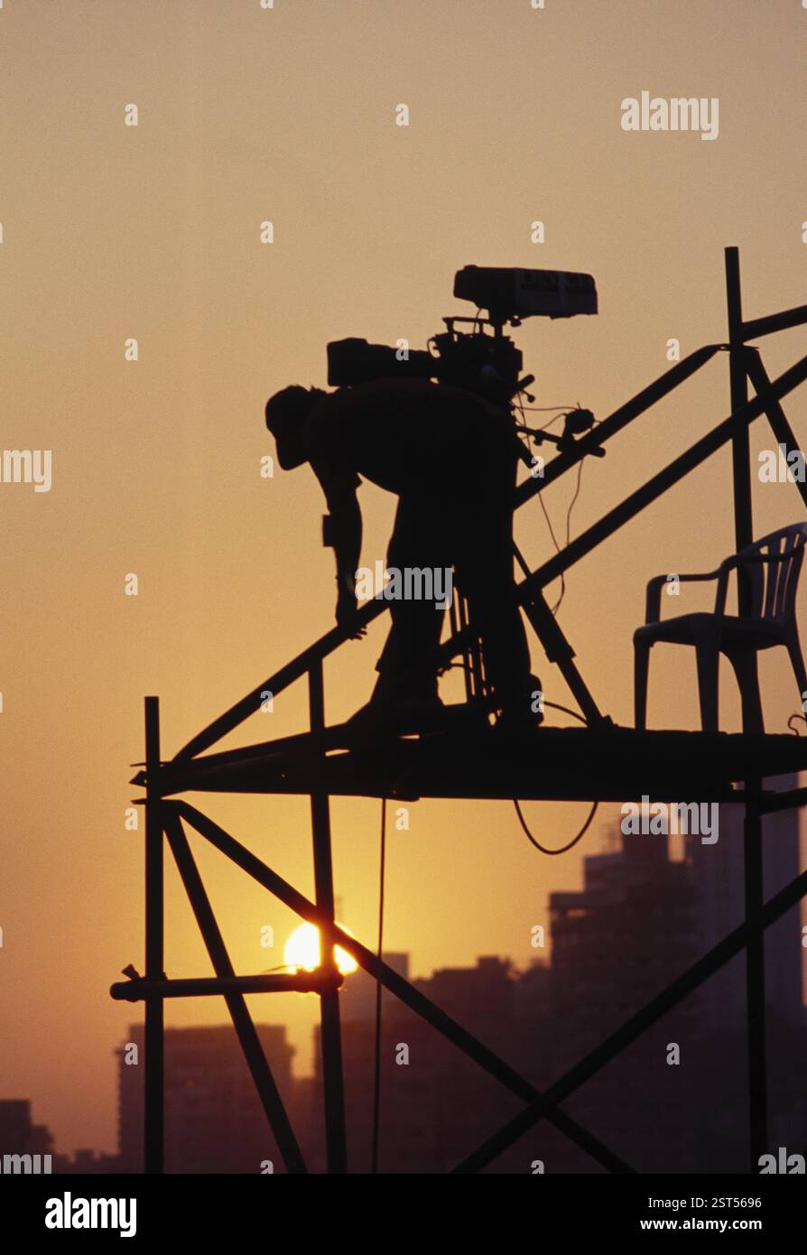 Man fitting television camera on stage, india Stock Photo - Alamy