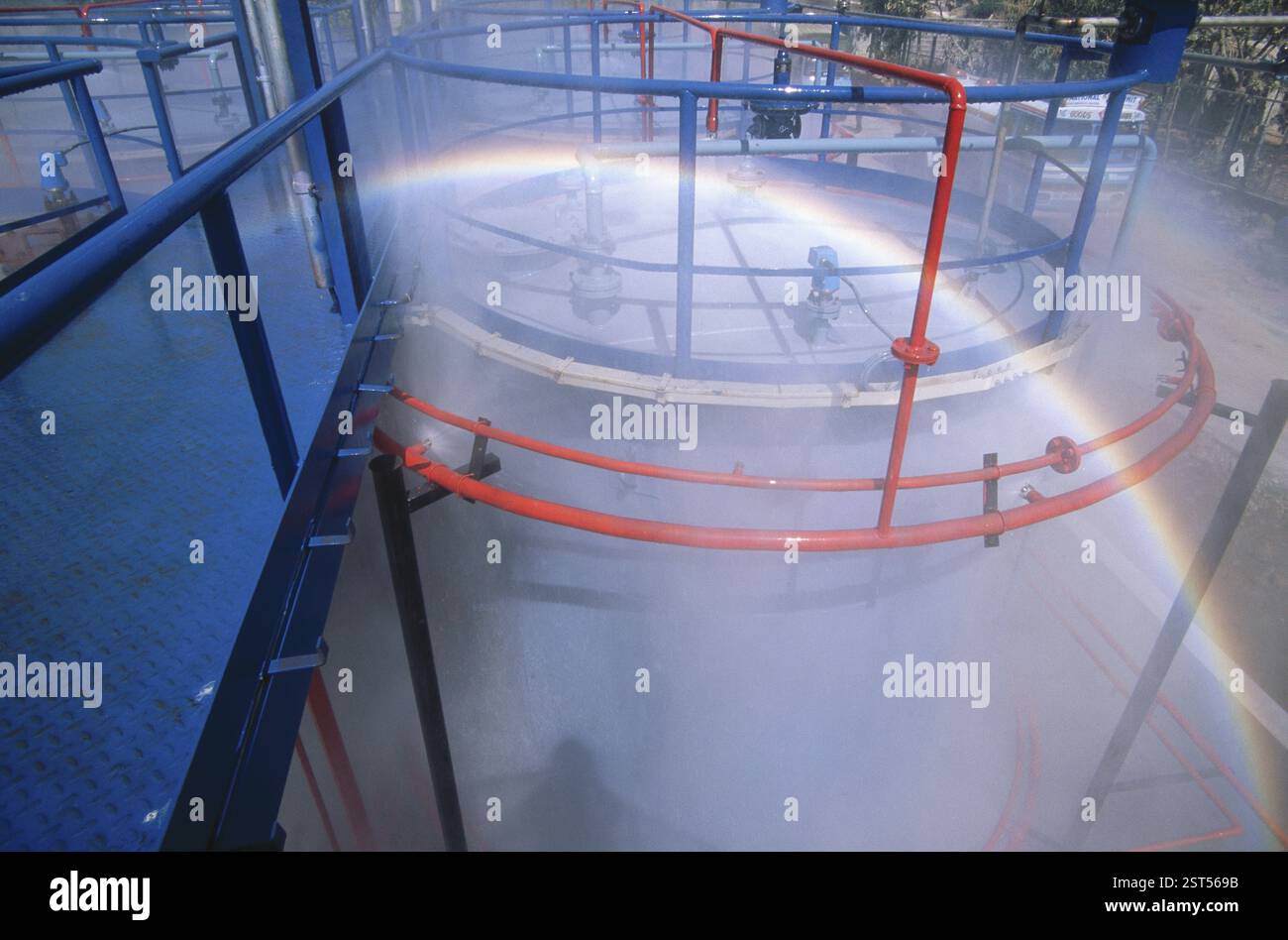 Rainbow, water sprinklers on storage tank, india Stock Photo - Alamy