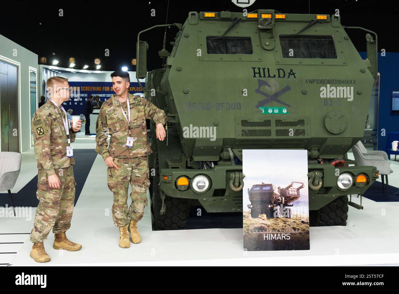 Two U.S. soldiers stand by a HIMARS weapon system on display at the ...