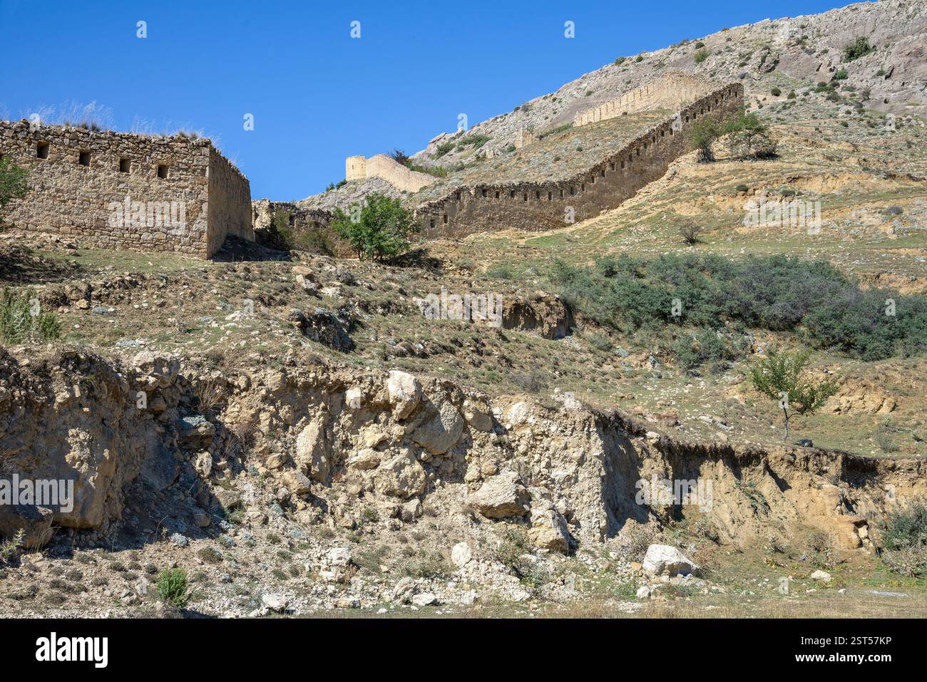 The ancient Gunib Fortress. Ruins of the protective wall. Republic of ...