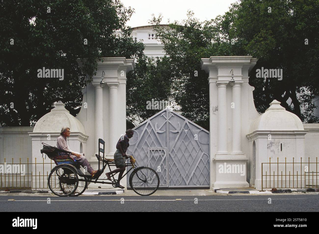 Cycle rickshaw rider passing near at old house, pondicherry union ...