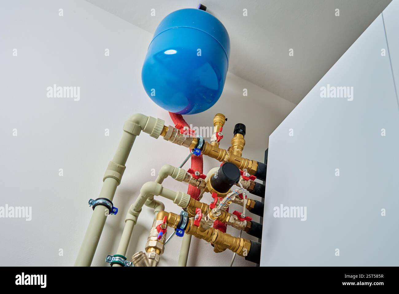 Closed heating system featuring expansion tank, pipes, and shut-off ...