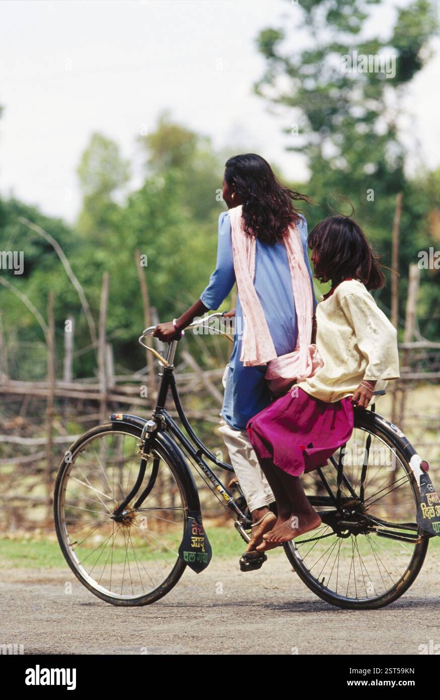 Girls riding cycle, bandogarh, madhya pradesh, india Stock Photo - Alamy