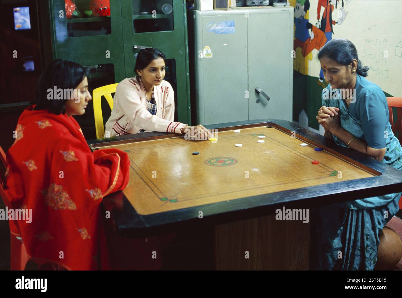 Family members playing carom game MR#152 Stock Photo - Alamy