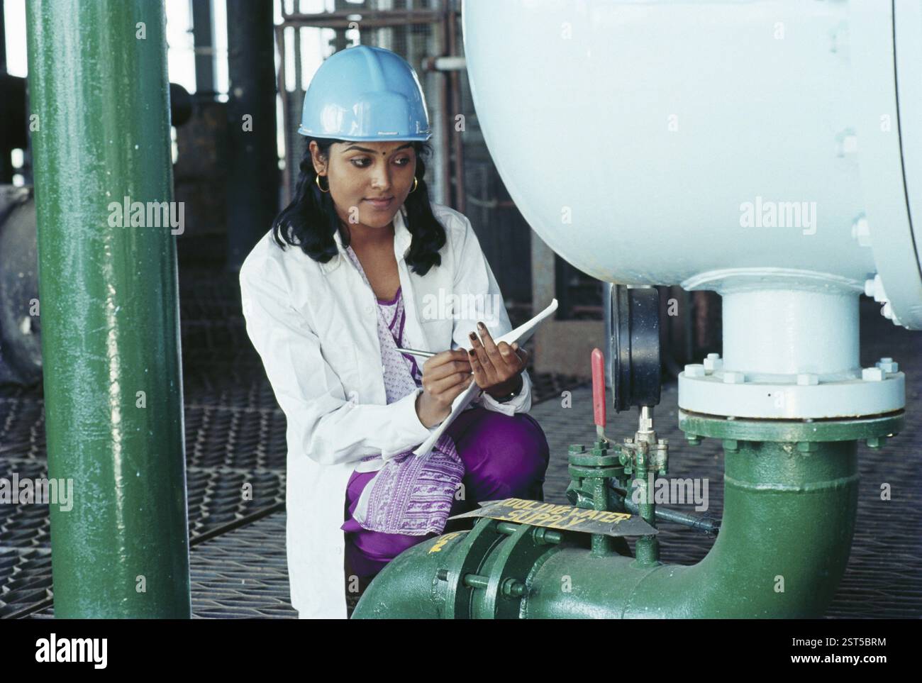 Woman taking records in chemical plant, india Stock Photo - Alamy