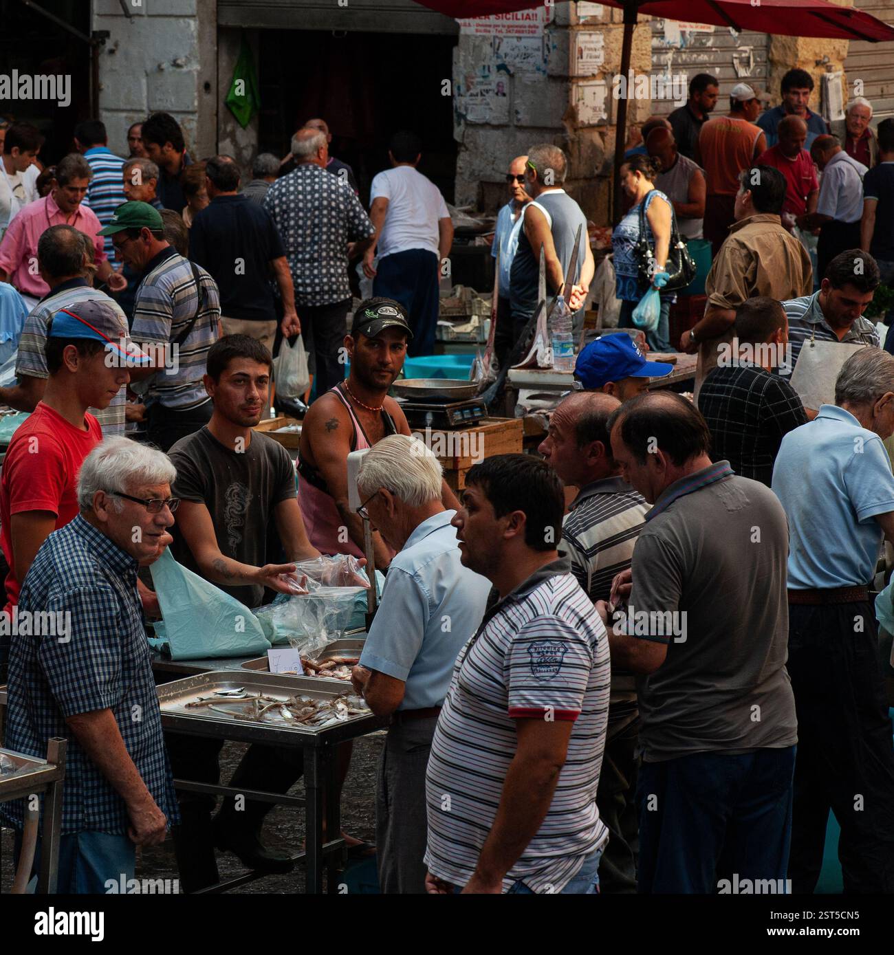 Fishing for bargains: late afternoon customers inspect the freshly ...