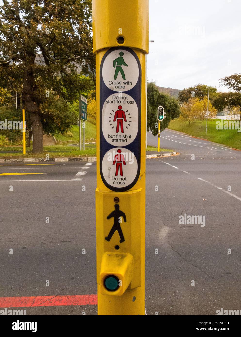 traffic light yellow pole showing stickers, signs educating pedestrians ...