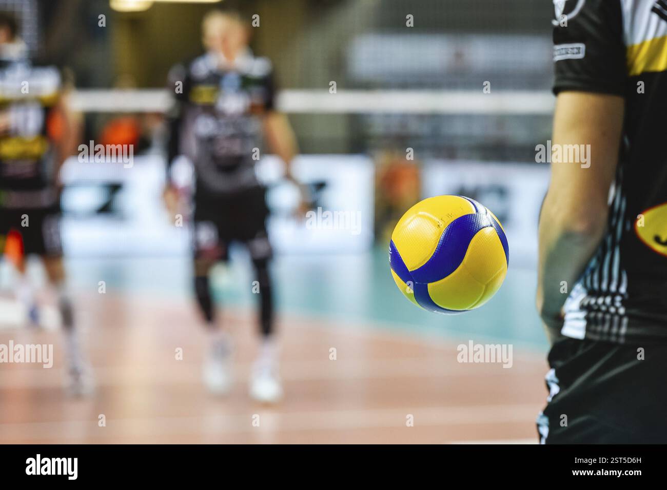 Volleyball ball flying near player before service with playing field in ...