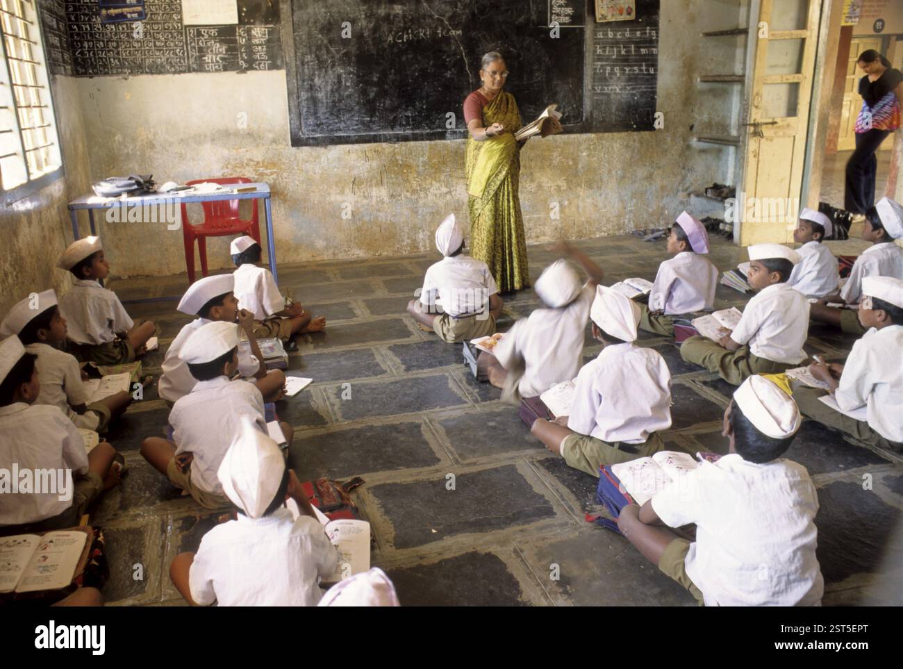 Lady Teacher teaching school children in classroom, sangli, maharashtra ...