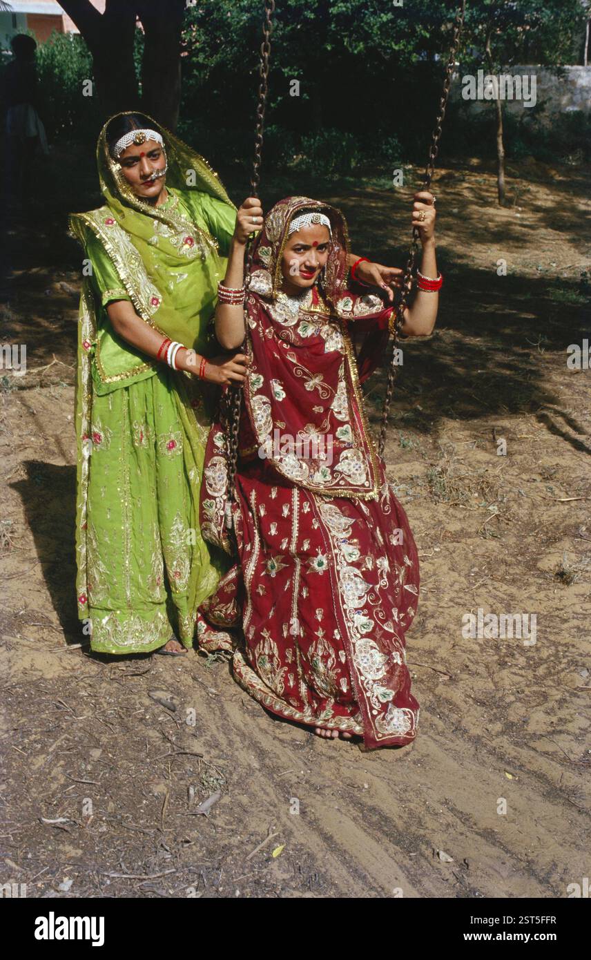 Women seated on swing, teej festival, india Stock Photo - Alamy