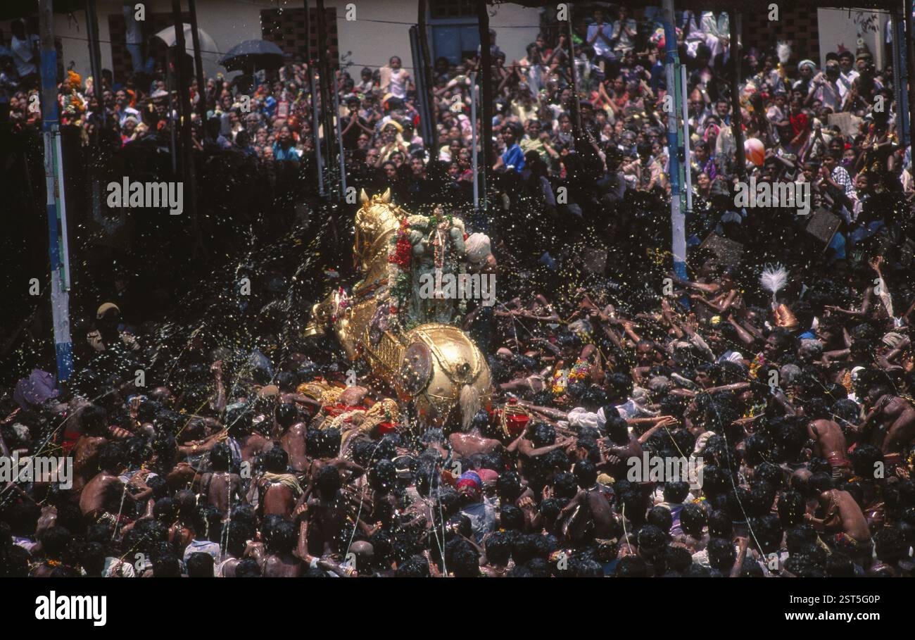 Ritual spraying of water on kallazhagar (vishnu), mounted on the golden ...