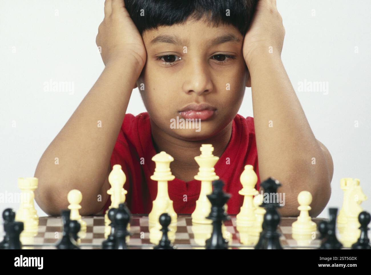 South Asian Indian boy playing chess MR#152 Stock Photo - Alamy
