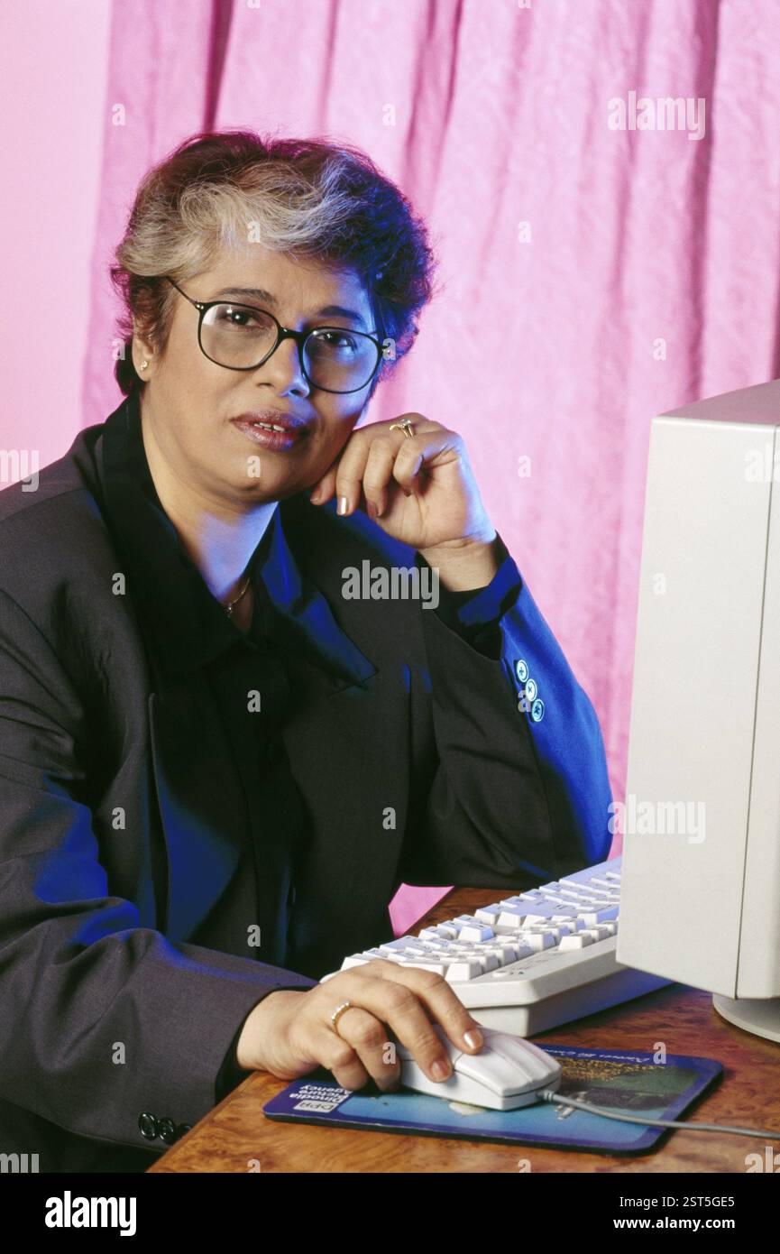 South Asian Indian executive lady sitting in front of computer MR#268 ...