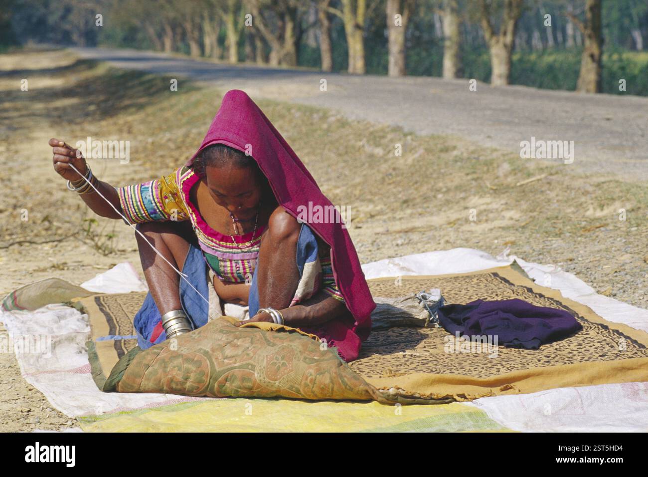 Woman stitching, tharu village tribal, dudwa, uttar pradesh, india ...