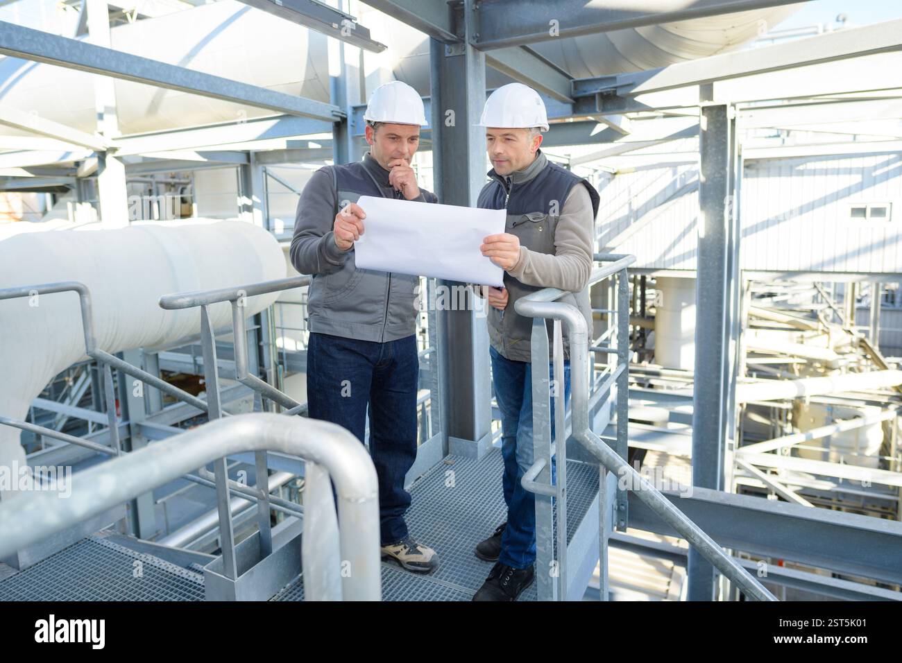 factory engineers studying a plan Stock Photo - Alamy