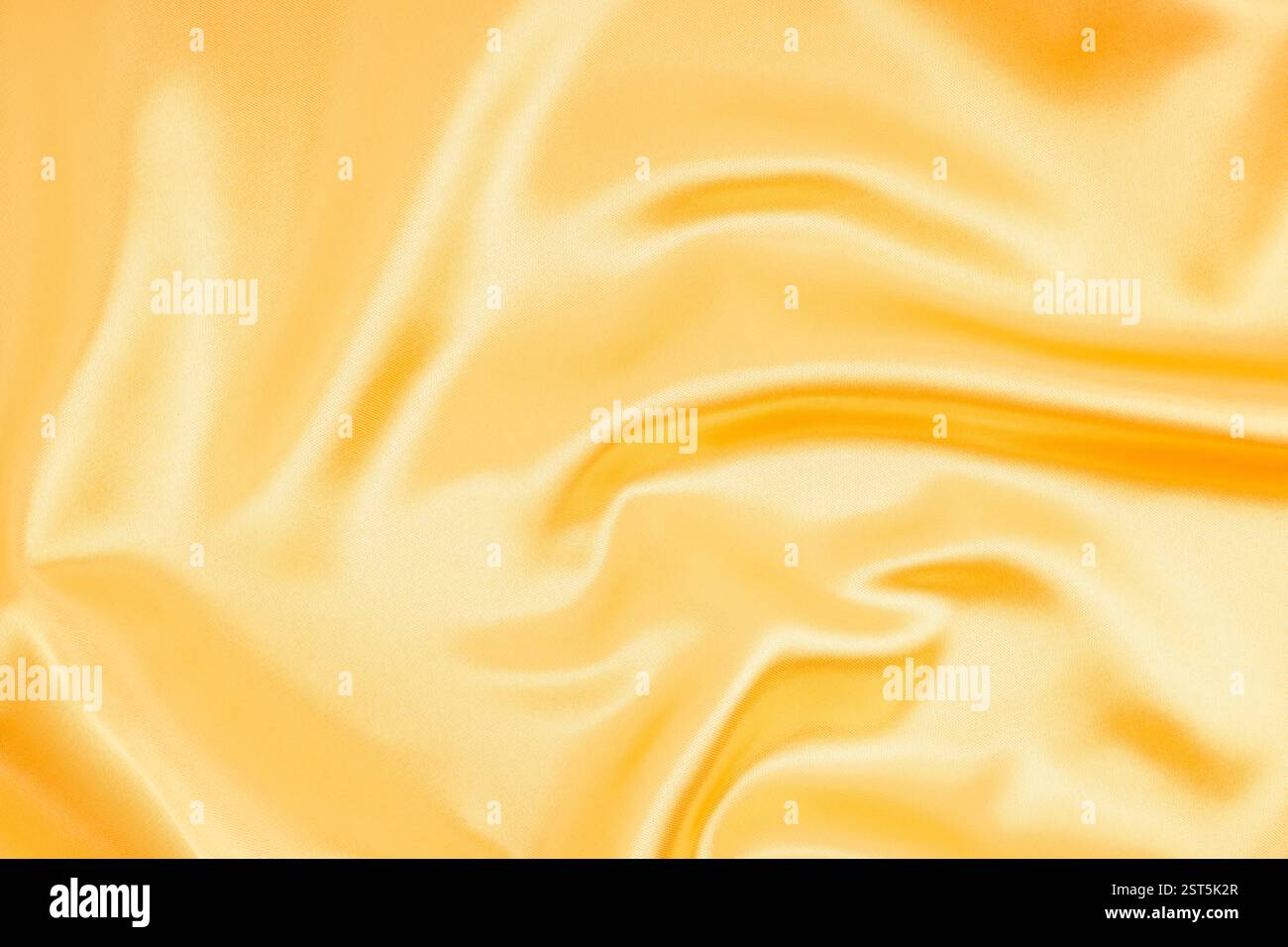 background of bright yellow silk with waves, Abstract as background ...