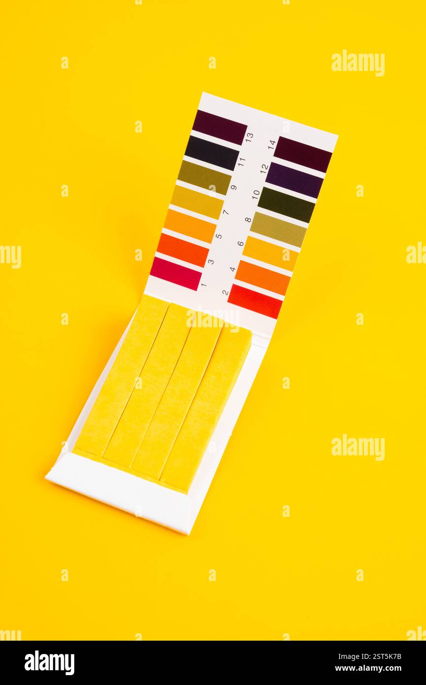 universal indicator paper with acidic testing on yellow background ...