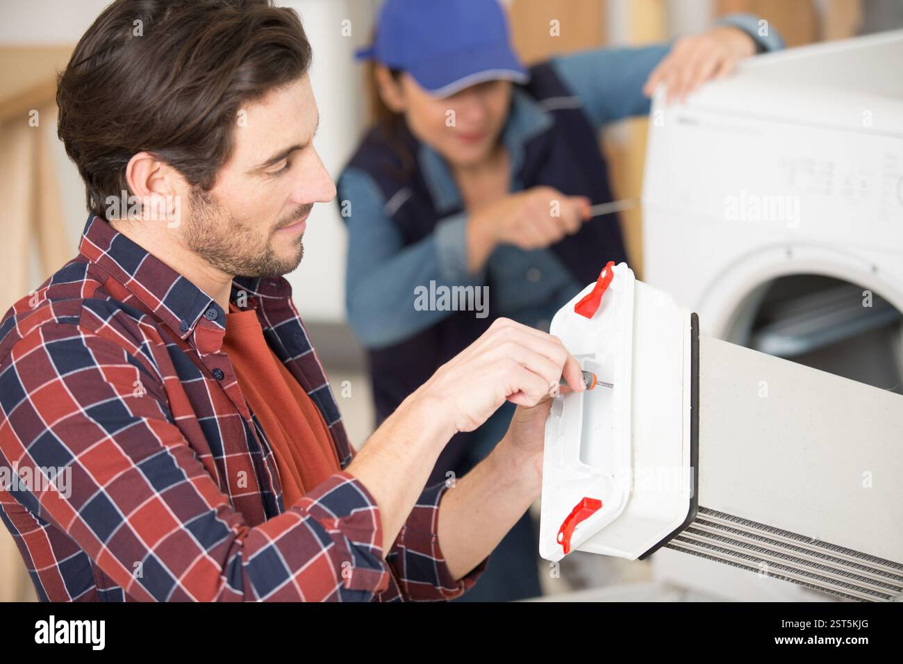 Female repairing washing machine hi-res stock photography and images ...