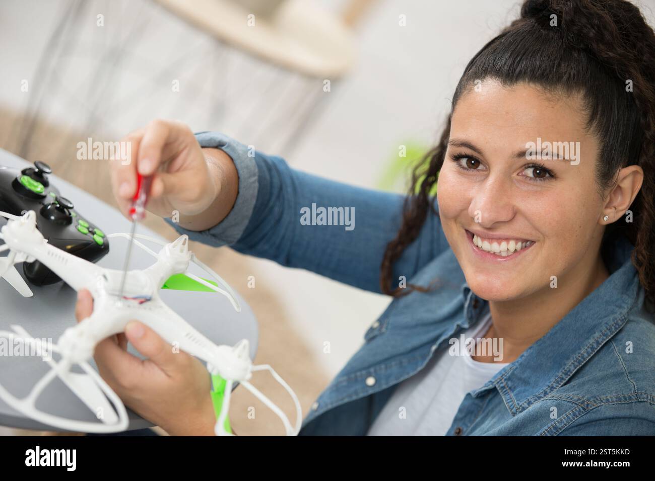 happy female drone pilot dismantling drone Stock Photo - Alamy