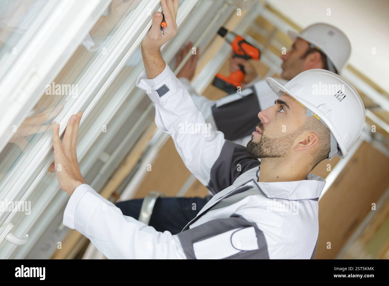 window builder working on mount of new installation Stock Photo - Alamy