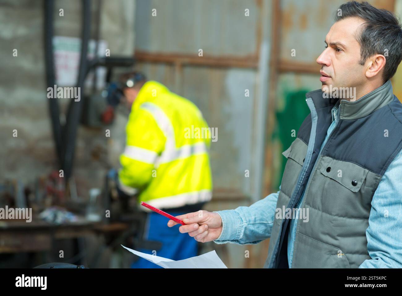 businessman giving directions at warehouse Stock Photo - Alamy
