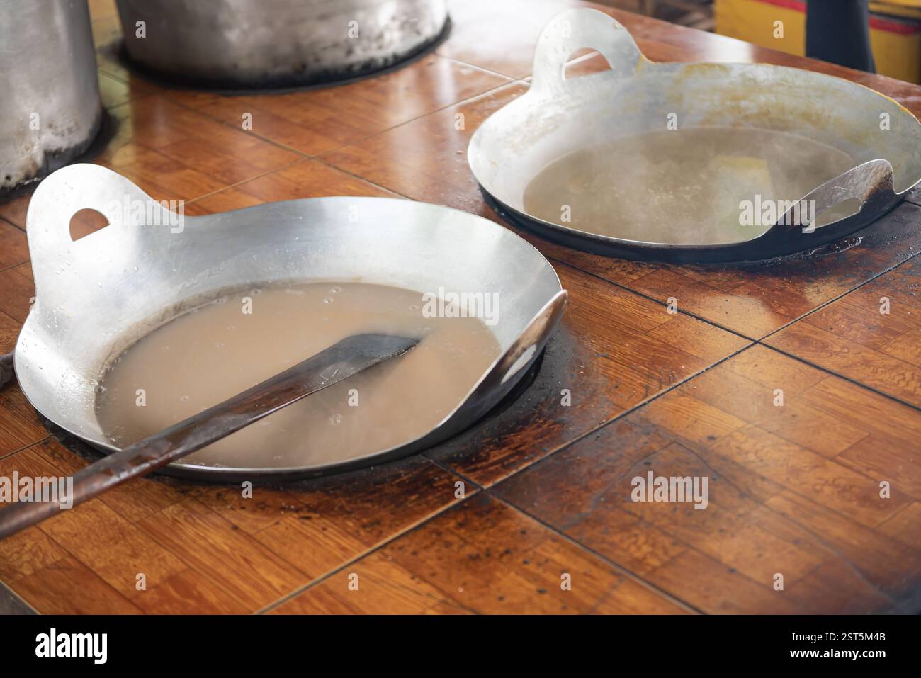 Mixture of squeezed coconut milk, cream, sugar and malt syrup in flat ...