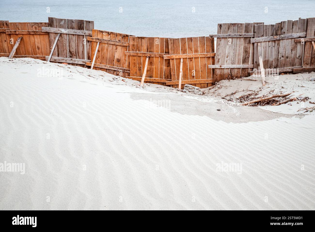 Wooden fence on a beach with smooth white sand, selective focus Stock ...