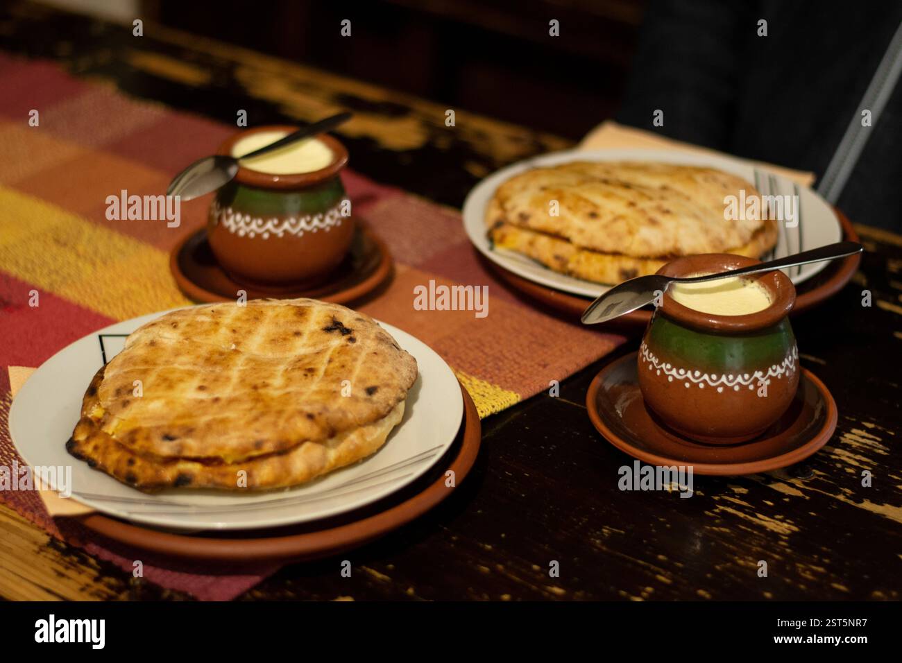 Traditional Serbian komplet lepinja buns and sour milk Stock Photo - Alamy