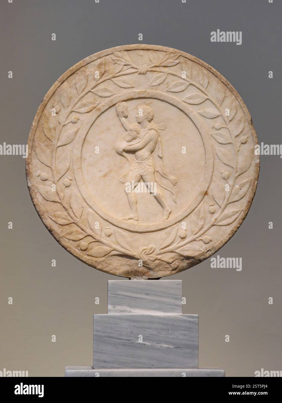 Athens. Greece. Marble disk decorated with a relief of a Satyr carrying ...