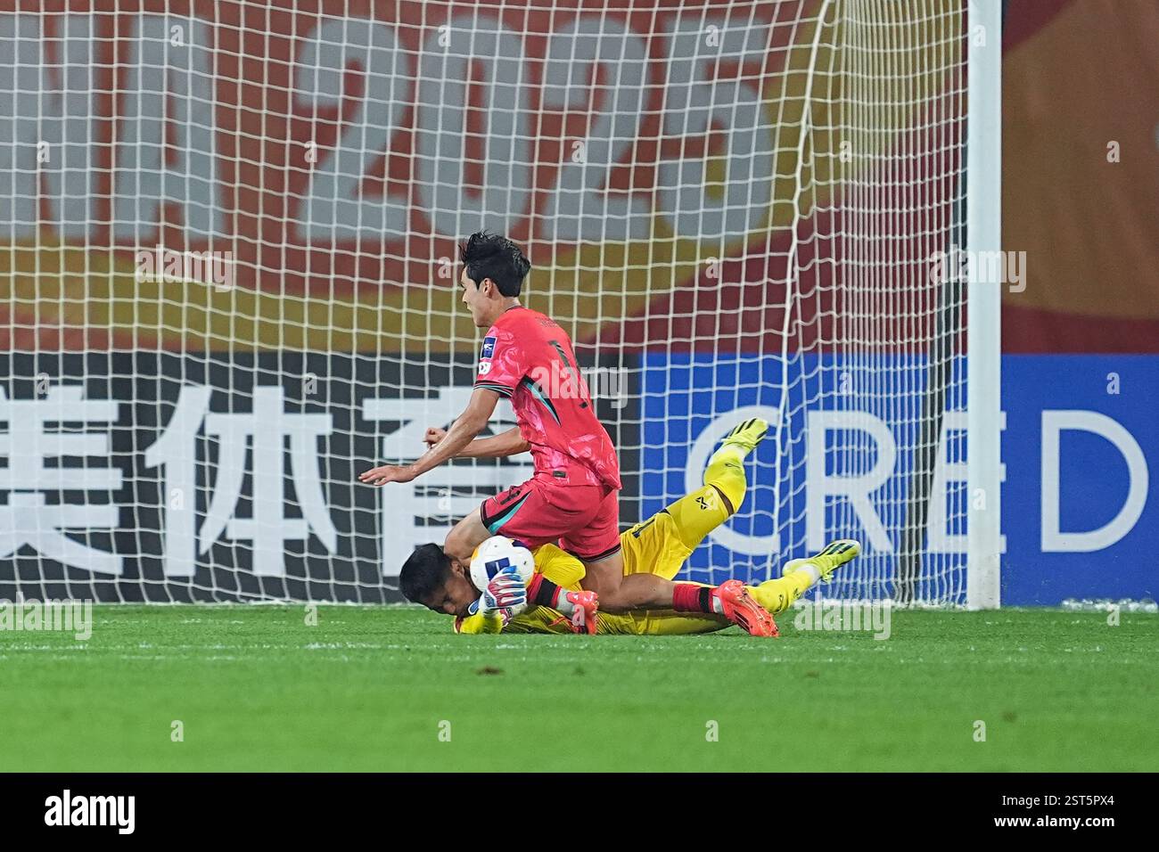 Shenzhen, China's Guangdong Province. 17th Feb, 2025. Baek Mingyu (top) of South Korea vies with ...