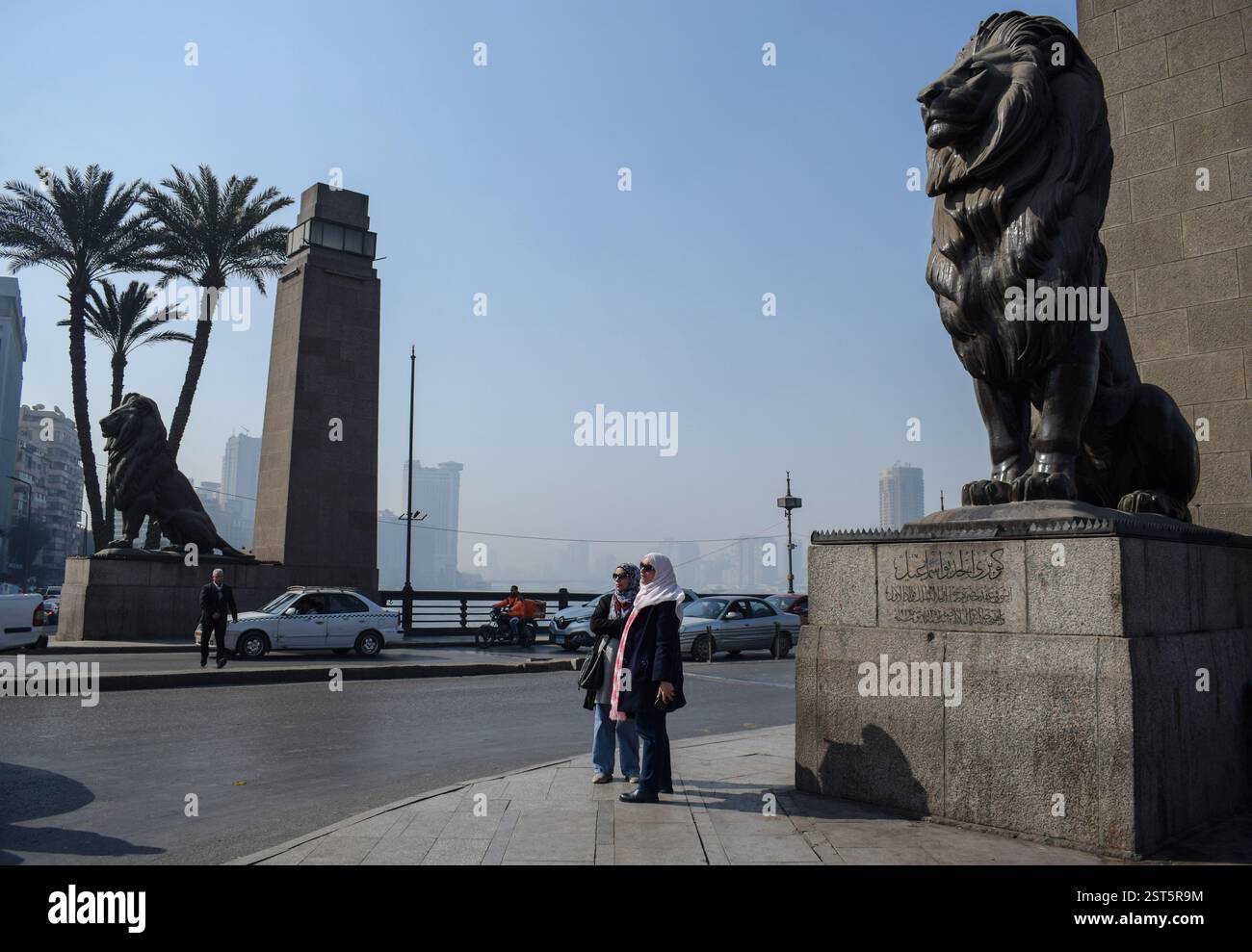 Cairo, Egypt, 17 February 2025. Passersby stand ahead of the bronze lions at the Qasr El Nil ...