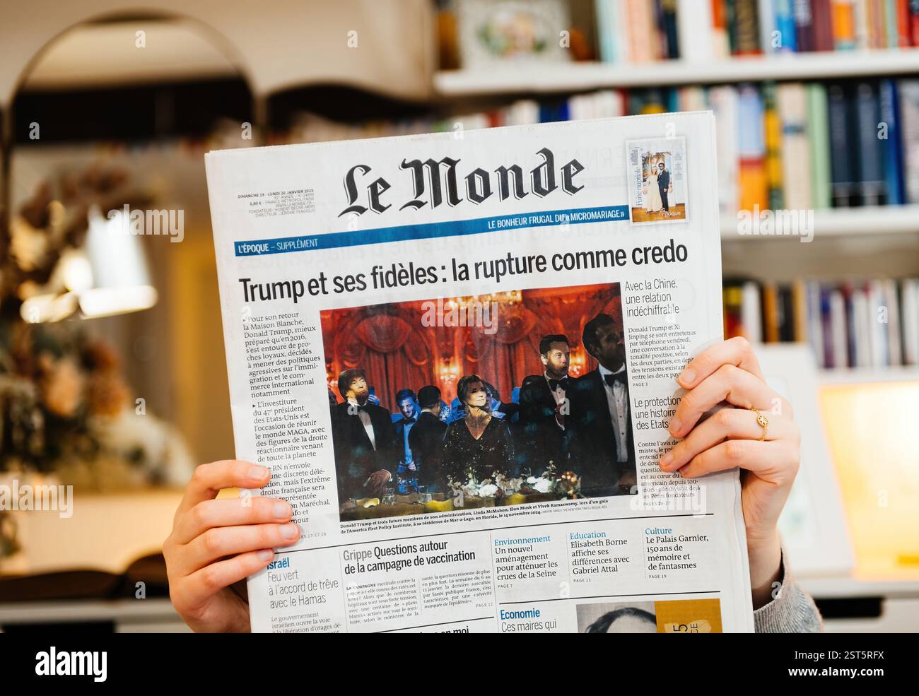 Paris, France - Jan 20, 2025: A person holds a Le Monde newspaper with ...