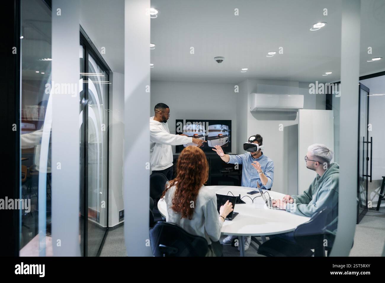 A diverse group of businessmen collaborates and tests a new virtual ...