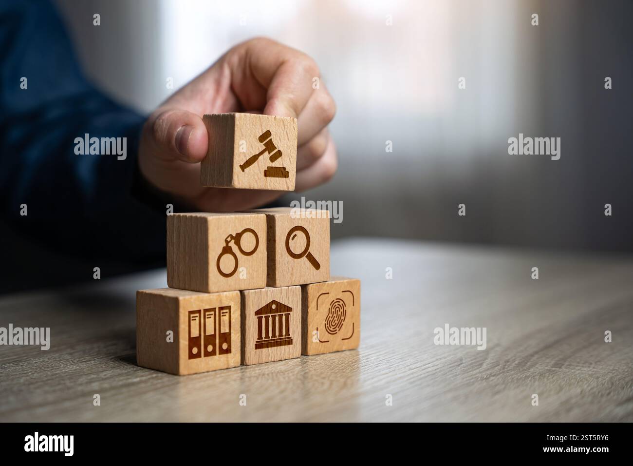 A man assembles a judicial system from blocks in the shape of a pyramid ...