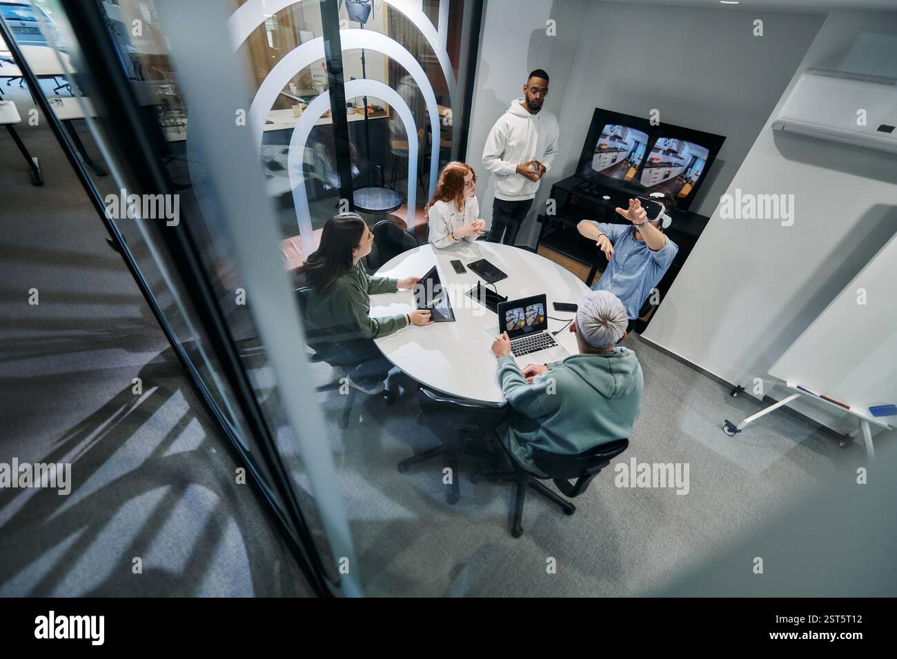 A diverse group of businessmen collaborates and tests a new virtual ...
