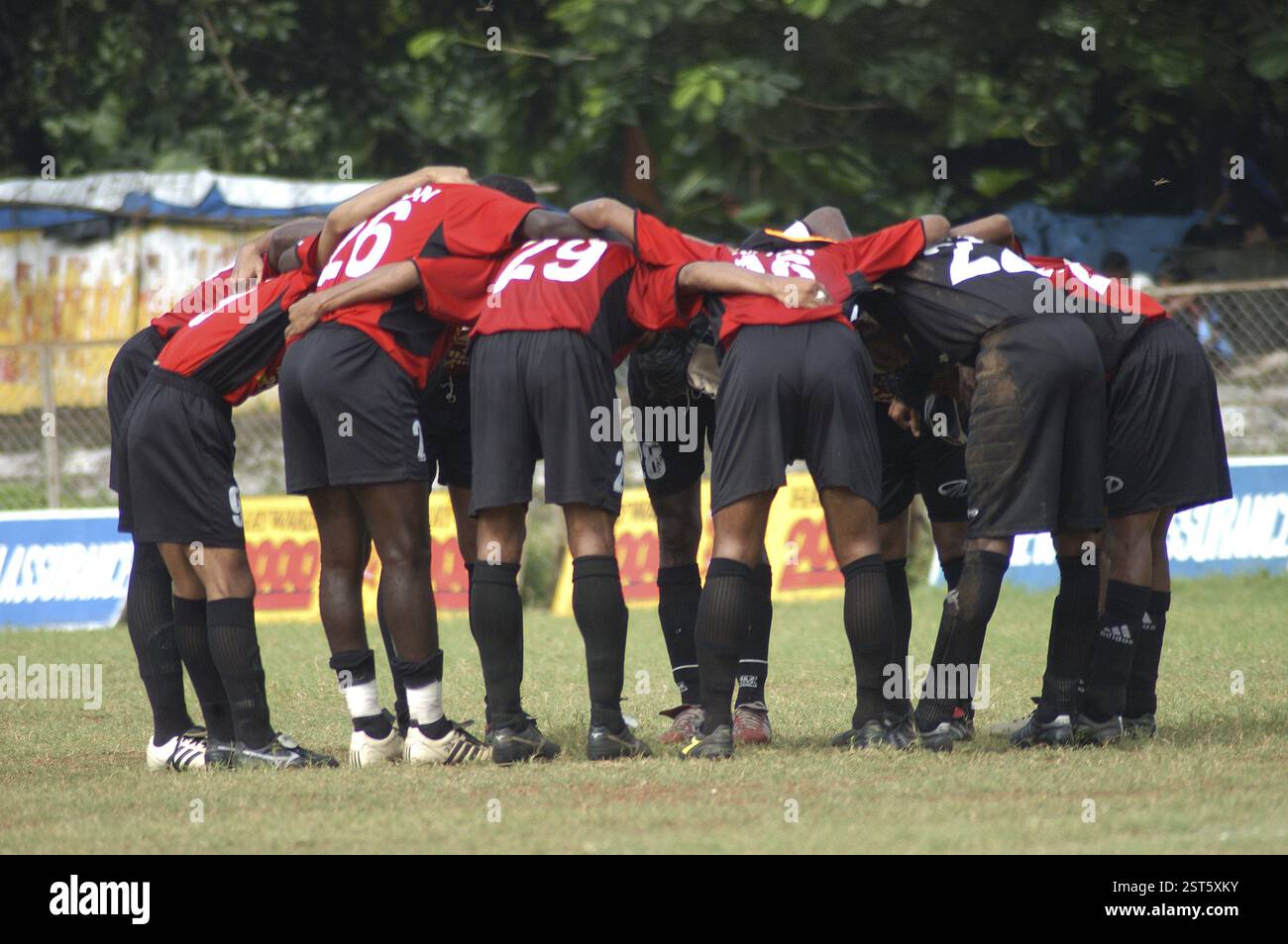 Players pray before the start of the Football match at Cooperage ground ...
