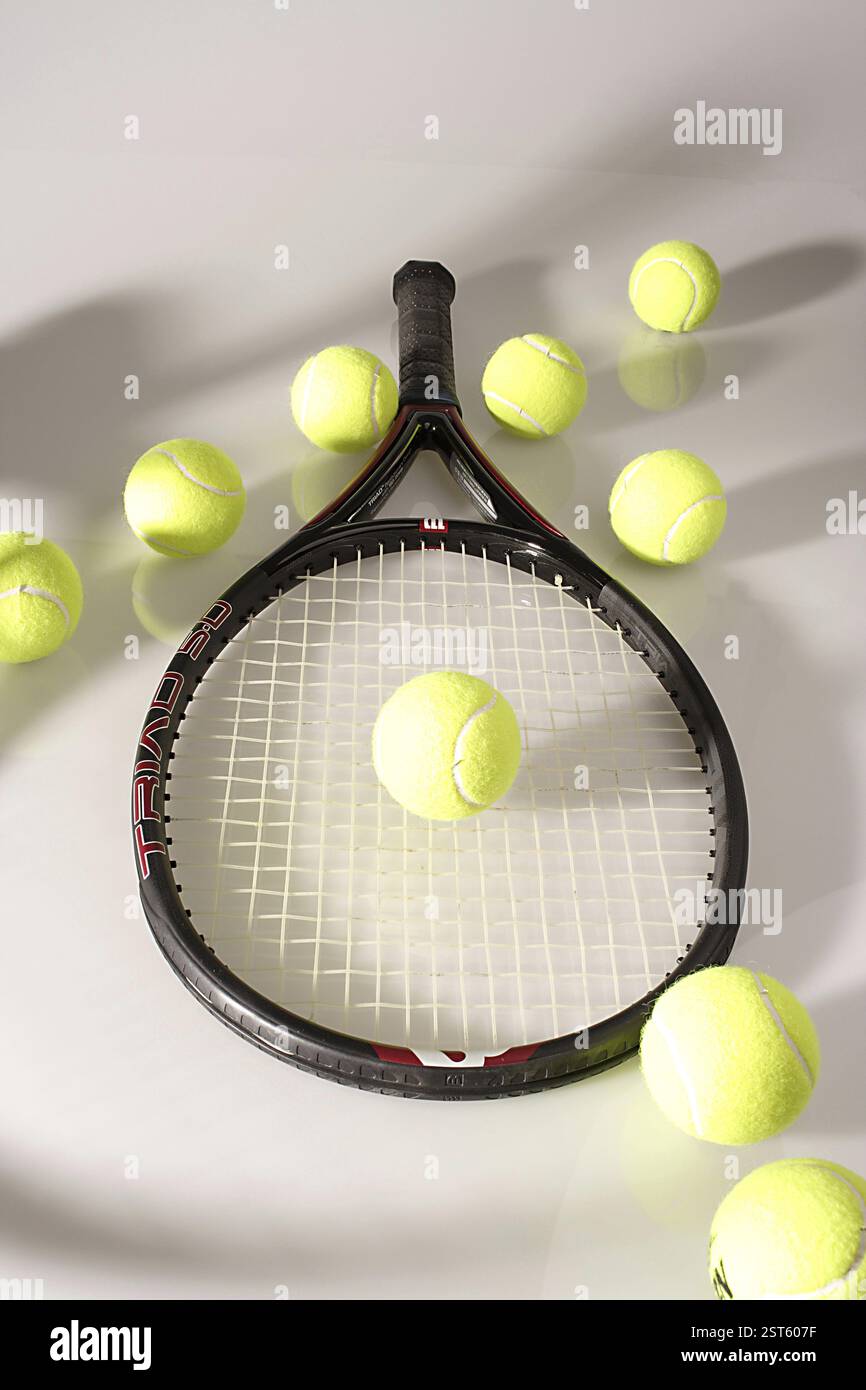 Tennis balls green with one racket and two balls bouncing off racket ...