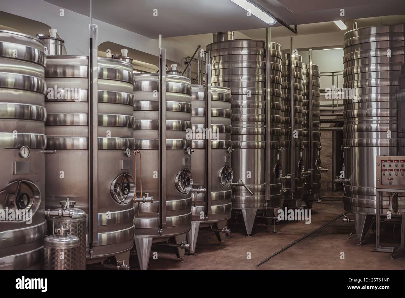 Large stainless steel fermentation tanks inside a modern winery ...