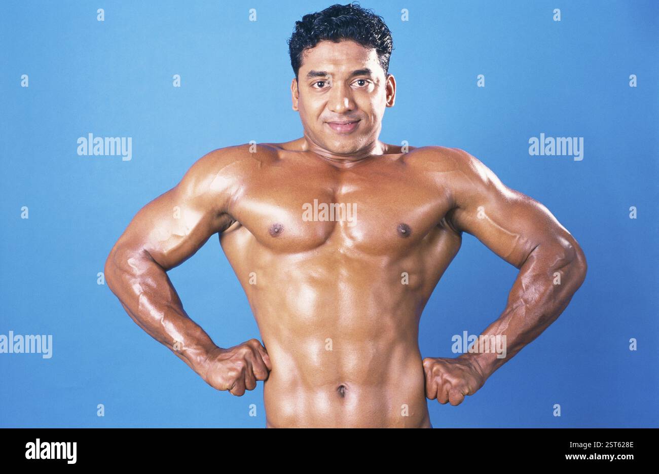 Body builder showing front lateral spread MR#411 Stock Photo - Alamy