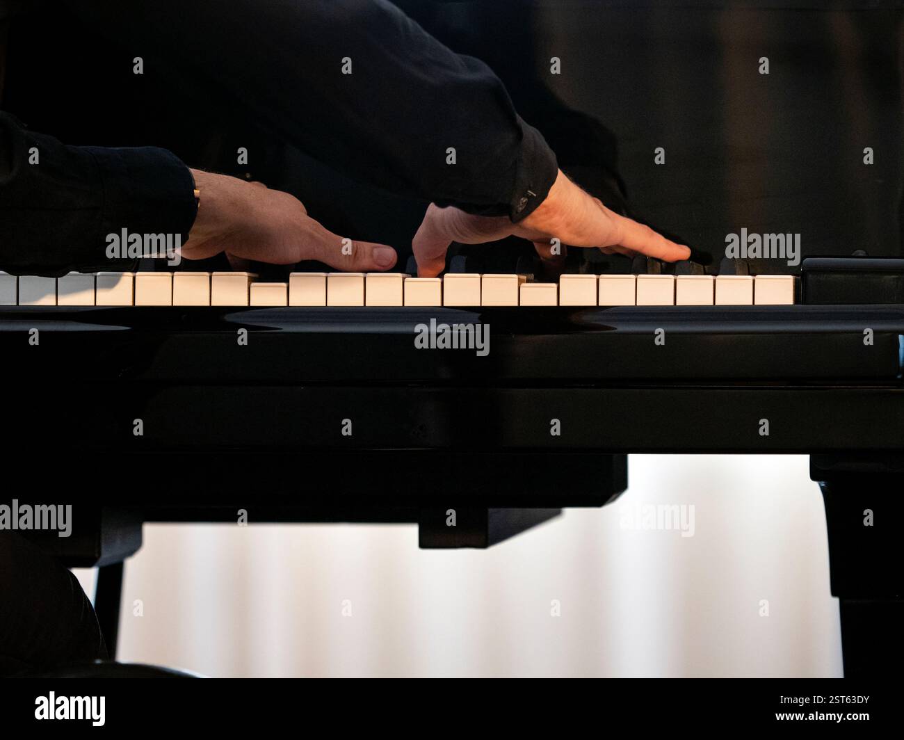 Detail of a musician's hands playing the piano Stock Photo - Alamy