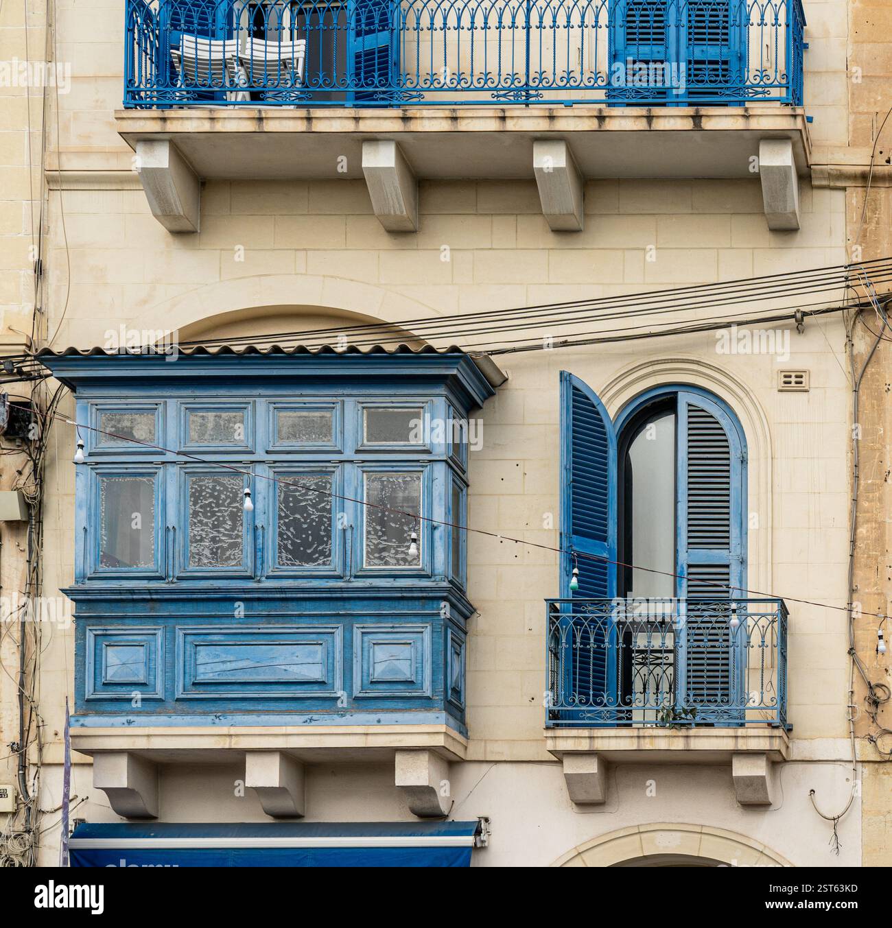 Traditional house detail in Malta. Limestone yellow bricks and colorful ...