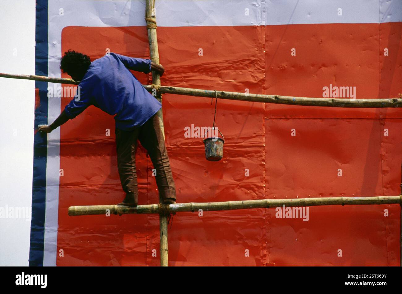Painter painting red color, Ernakulum, India, Asia Stock Photo - Alamy