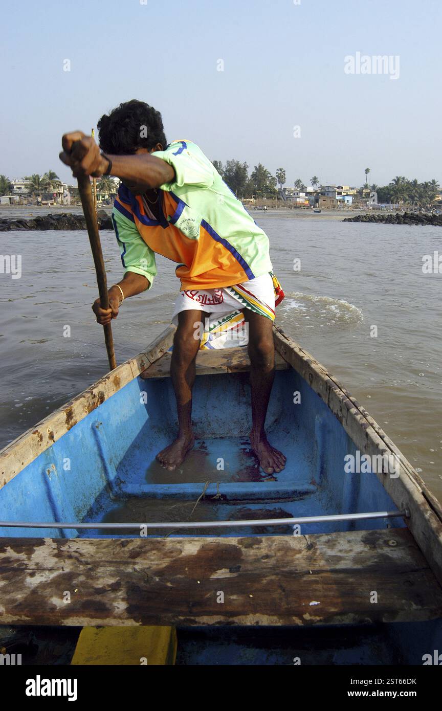 Indian fisherman leaves for fishing rowing a boat at Uttan Beach ...