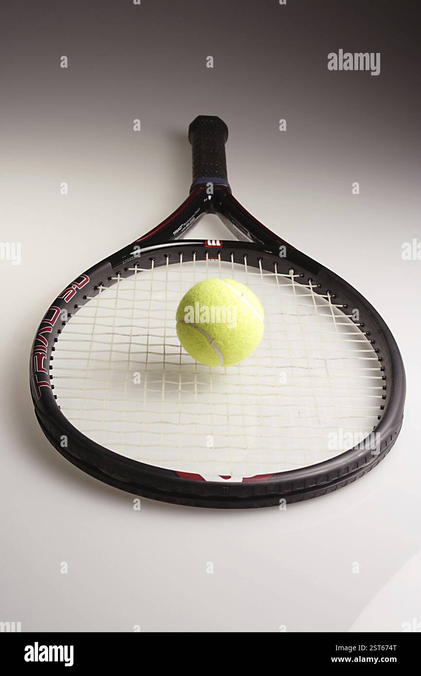 Tennis ball one green color with racket Stock Photo - Alamy