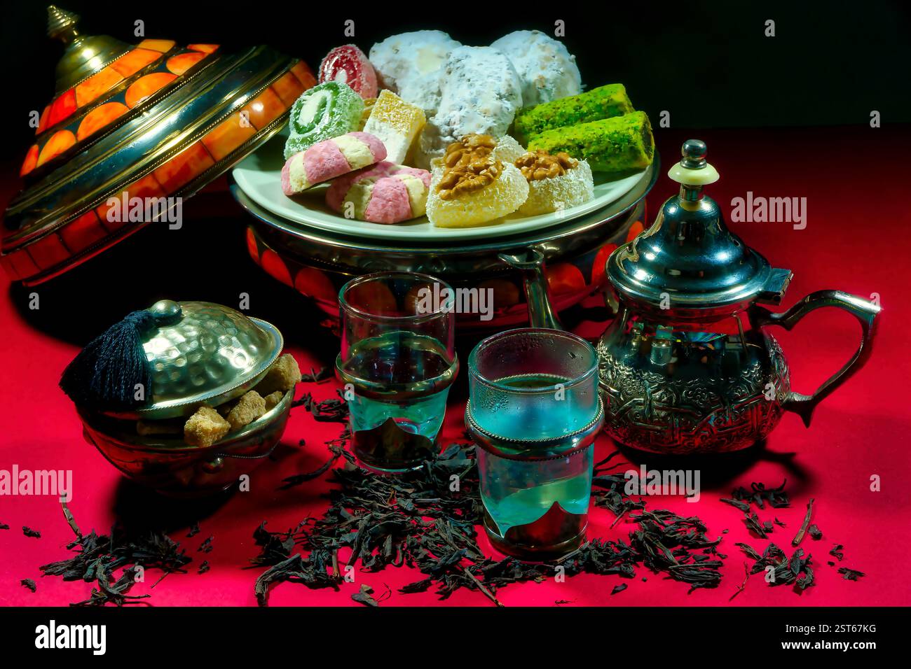 A view of some sweet delicacies presented in a silver container with a ...