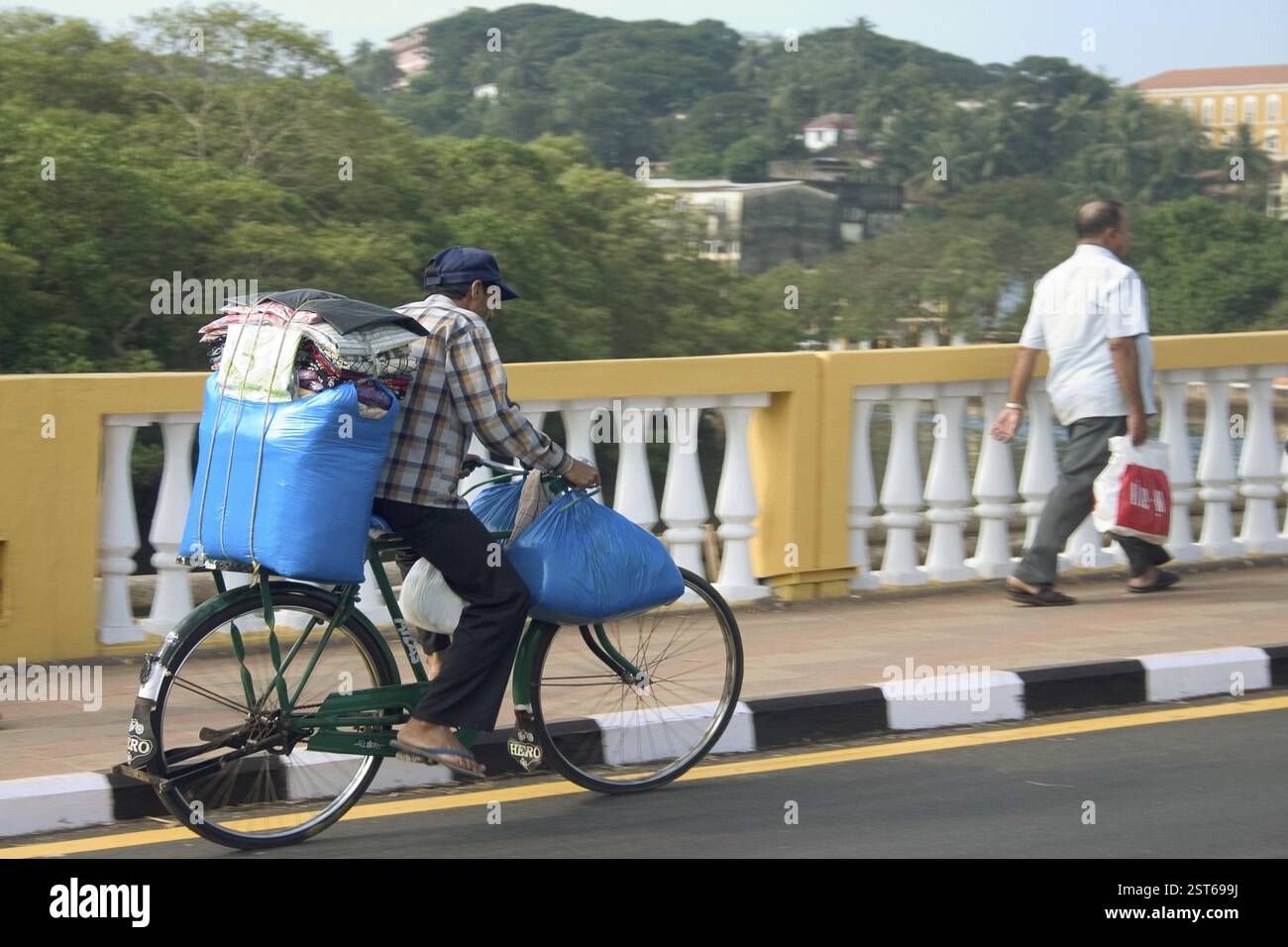 Blue luggage being transported on a bicycle over Old Pato bridge ...