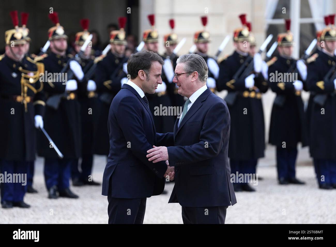 French President Emmanuel Macron, left, greets Britain's Prime Minister ...